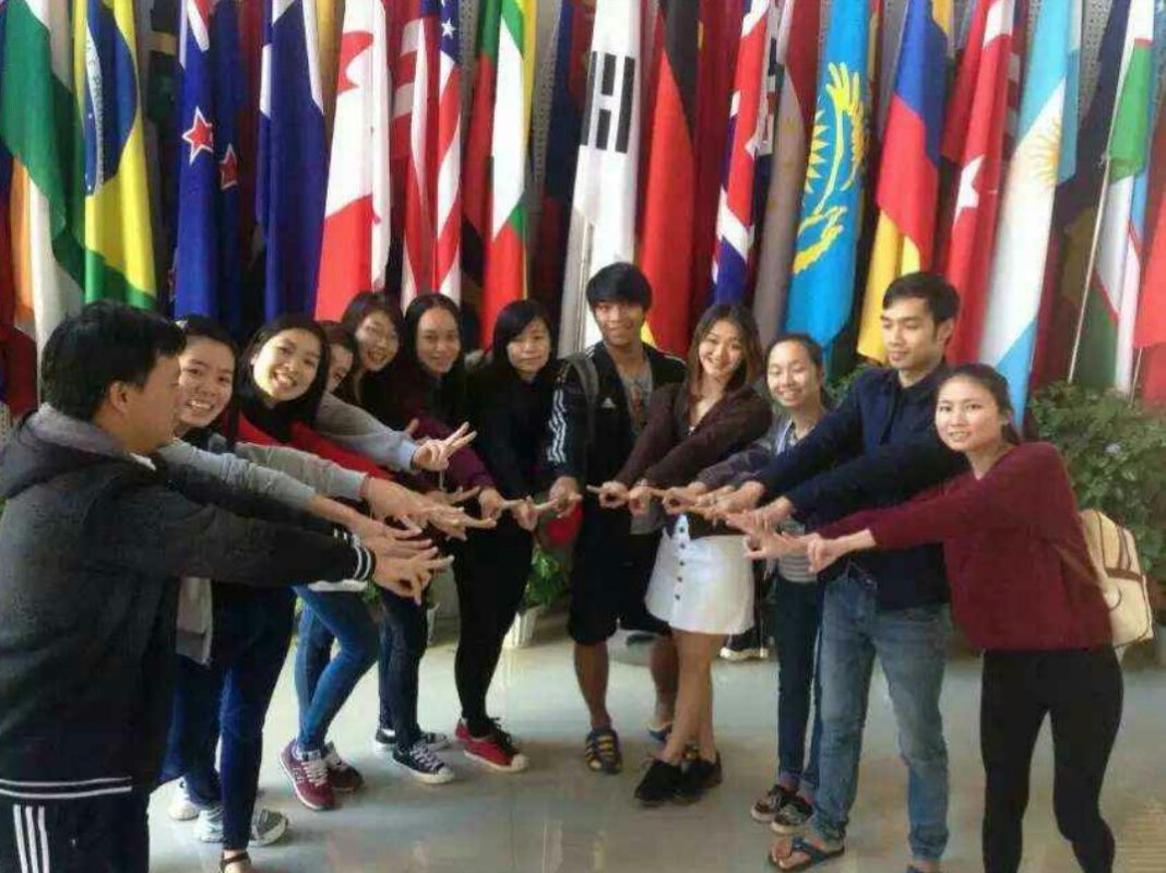 Burmese students standing in front of the national flags – Language on ...